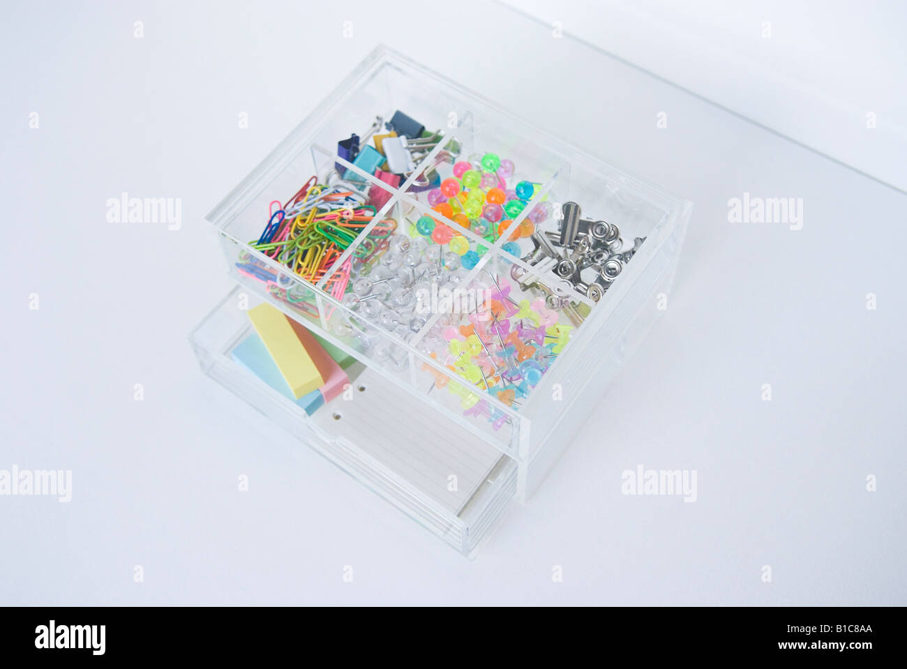 Clips and pushpins in plastic box Stock Photo - Alamy