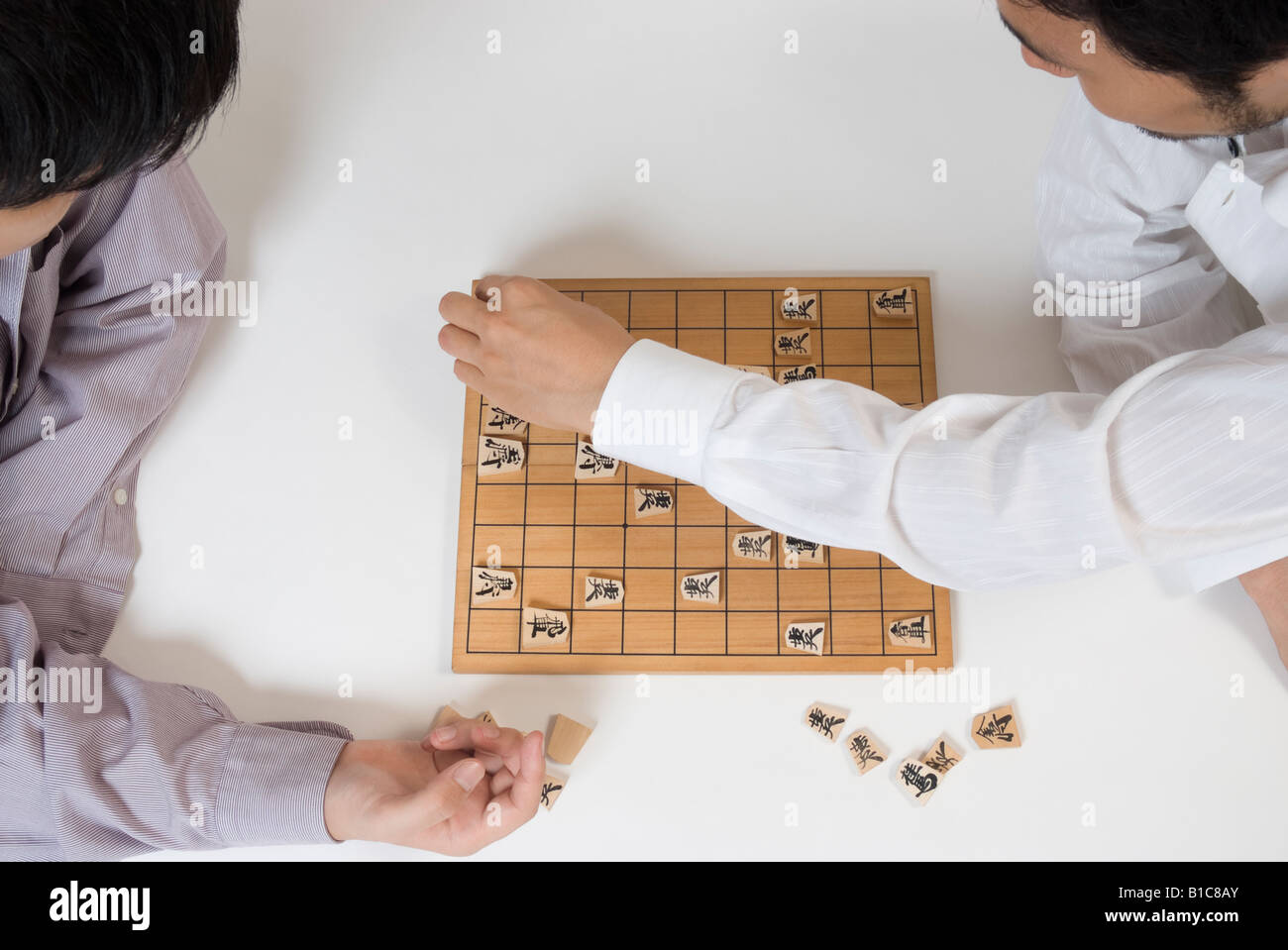 Two young men playing Japanese chess Stock Photo - Alamy
