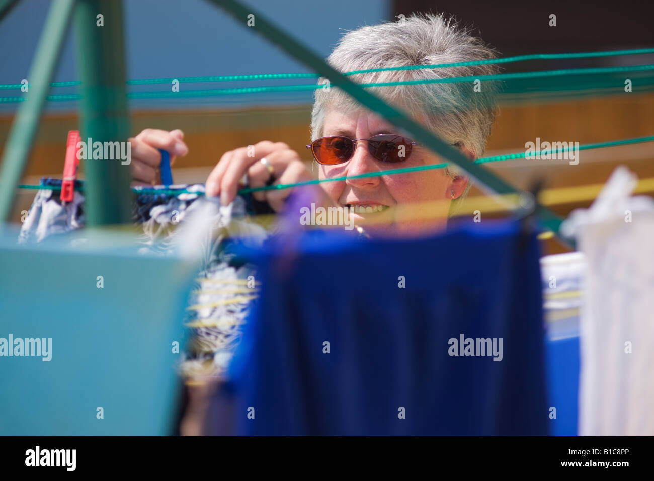 Lady hanging out the washing to dry Stock Photo - Alamy