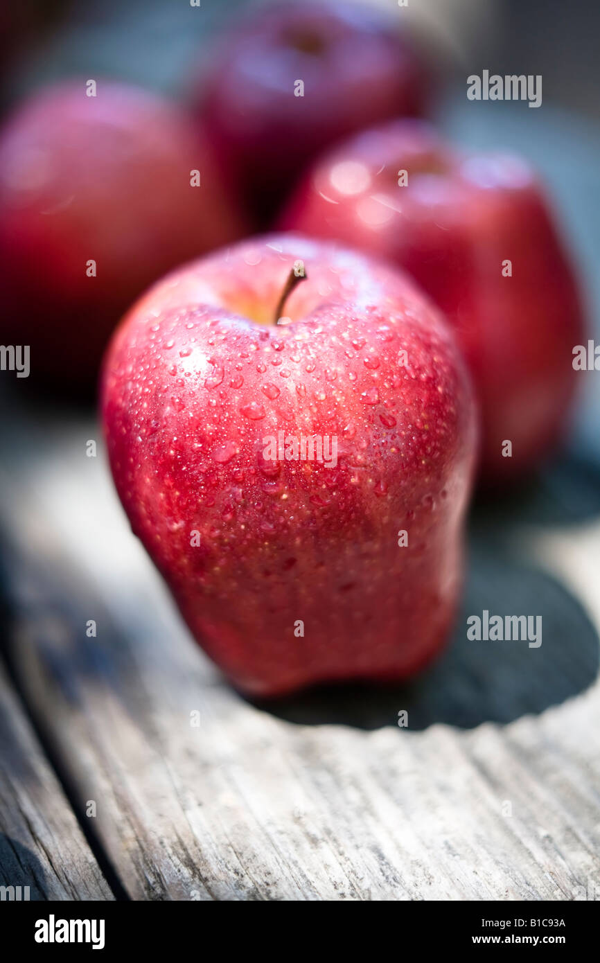 Red apples outside on a wood patio Stock Photo - Alamy
