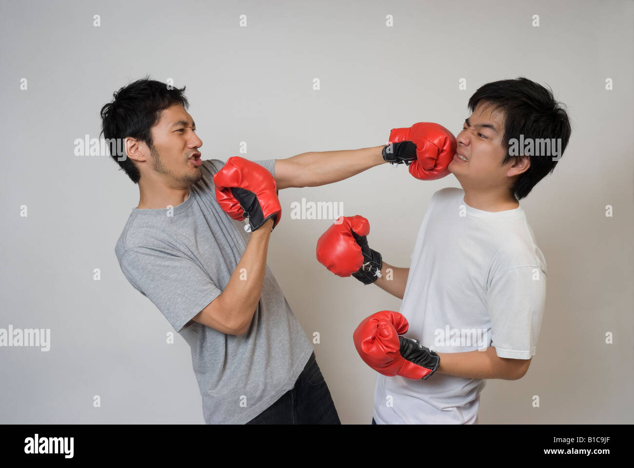 Two young men fighting Stock Photo - Alamy