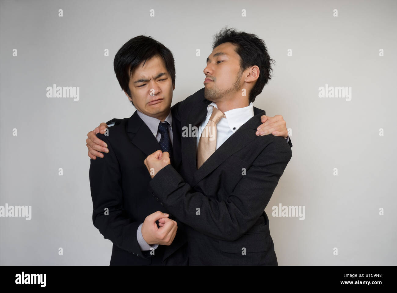 Two businessmen fighting Stock Photo - Alamy