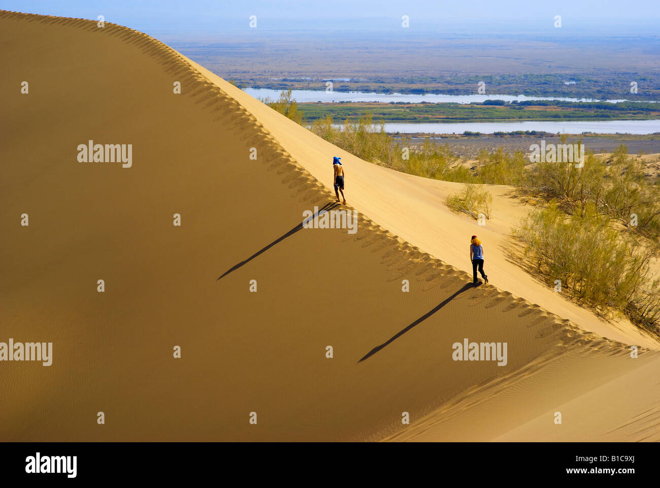 Two people on sun dune Stock Photo - Alamy