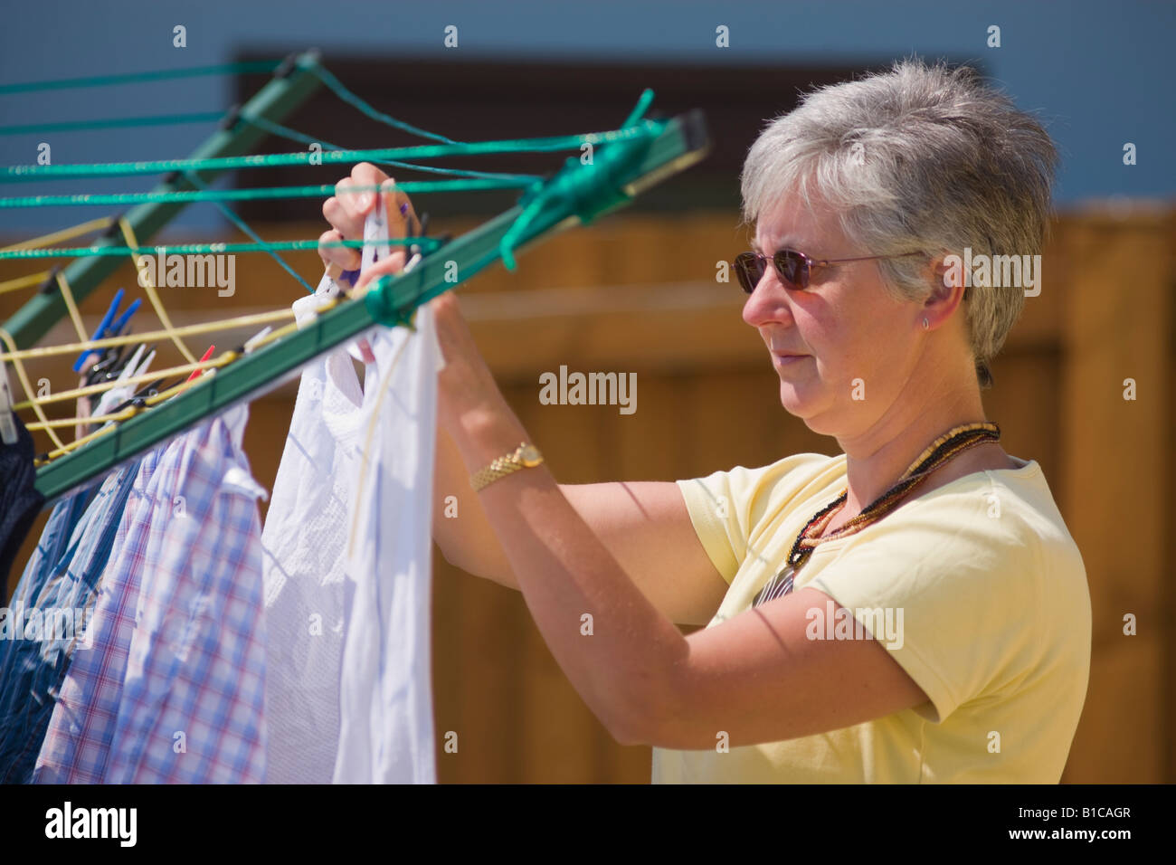 Woman hanging out washing on hi-res stock photography and images - Alamy