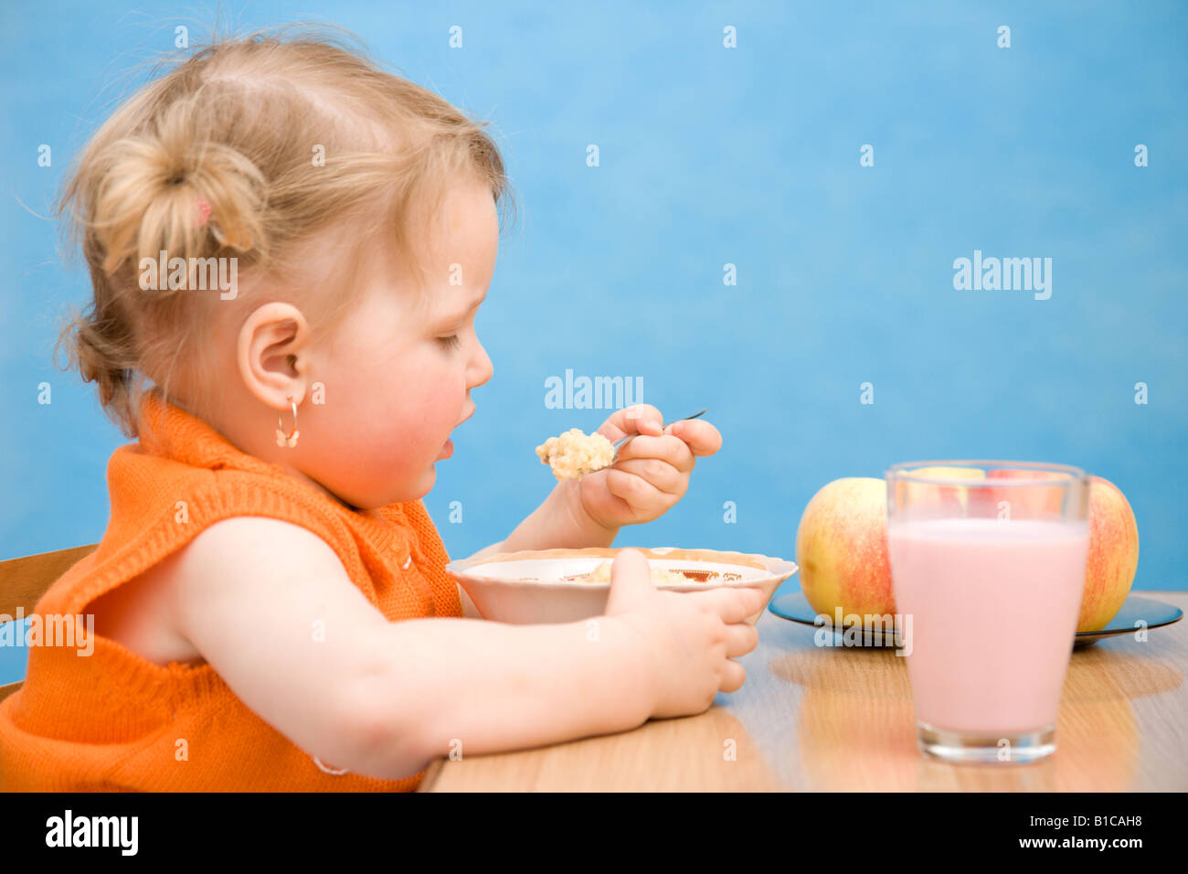Little girl eating baby food Stock Photo - Alamy