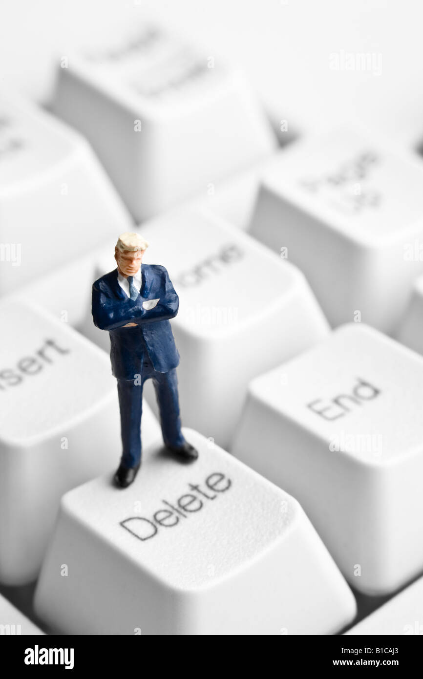 Businessman figurine standing on a computer keyboard Stock Photo - Alamy