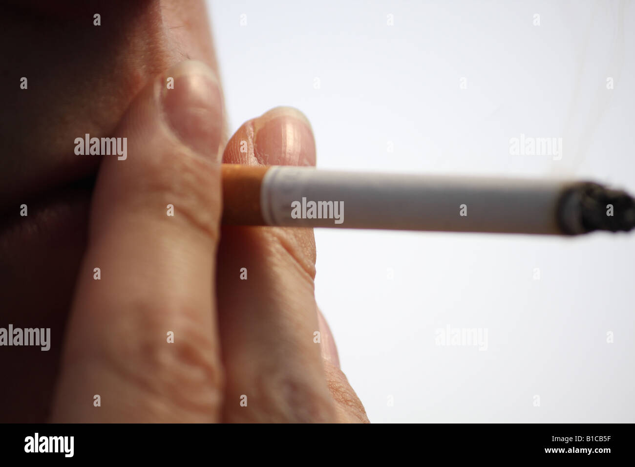A young female inhaling a cigarette Stock Photo - Alamy