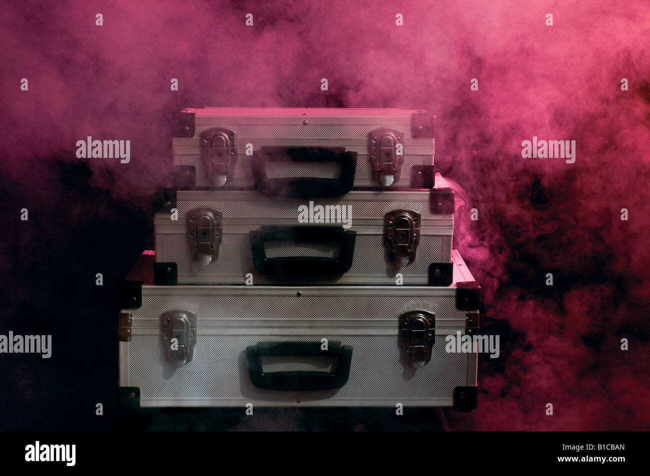 Stack of metal suitcases in smoke Stock Photo - Alamy