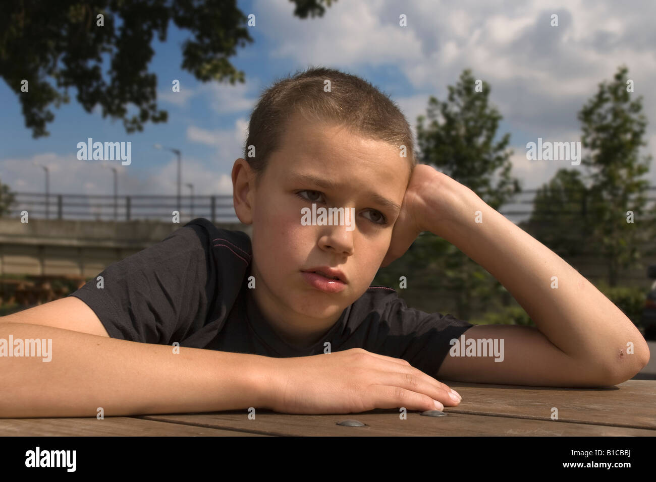 A short haired young teenage boy with a troubled expression Stock Photo ...