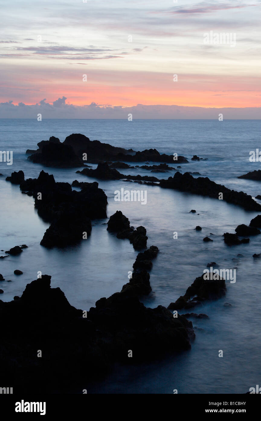 Rocky, volcanic coastline at sunset near Mosteiros on Sao Miguel Island ...