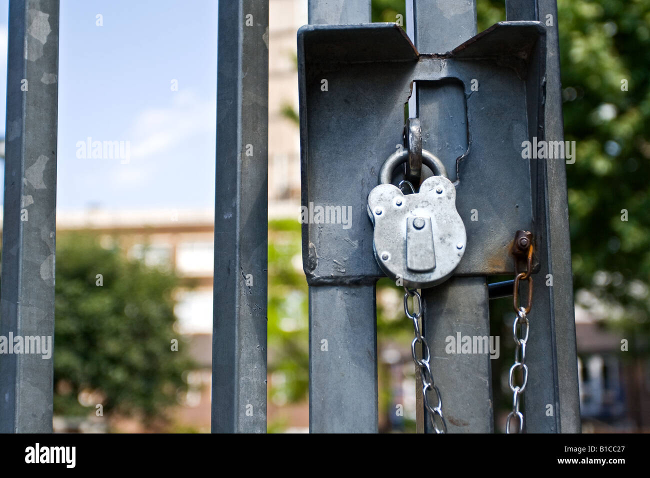 Padlock and chains on strong metal gate Stock Photo - Alamy