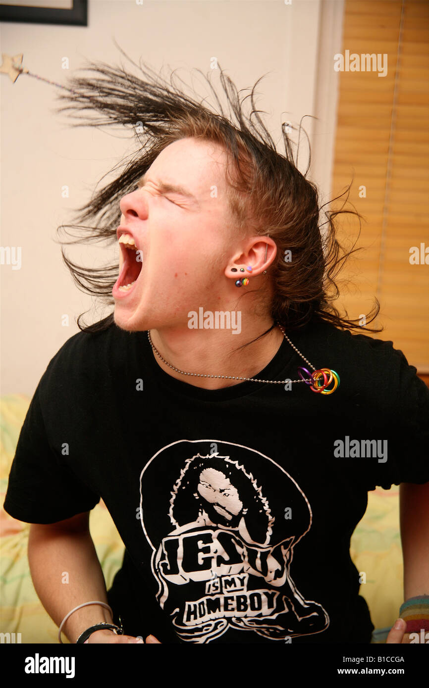 Headbanger teenage boy shouting and singing to music out of control ...