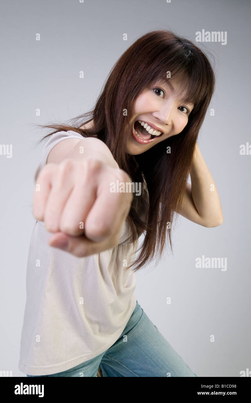 Young woman punching Stock Photo - Alamy