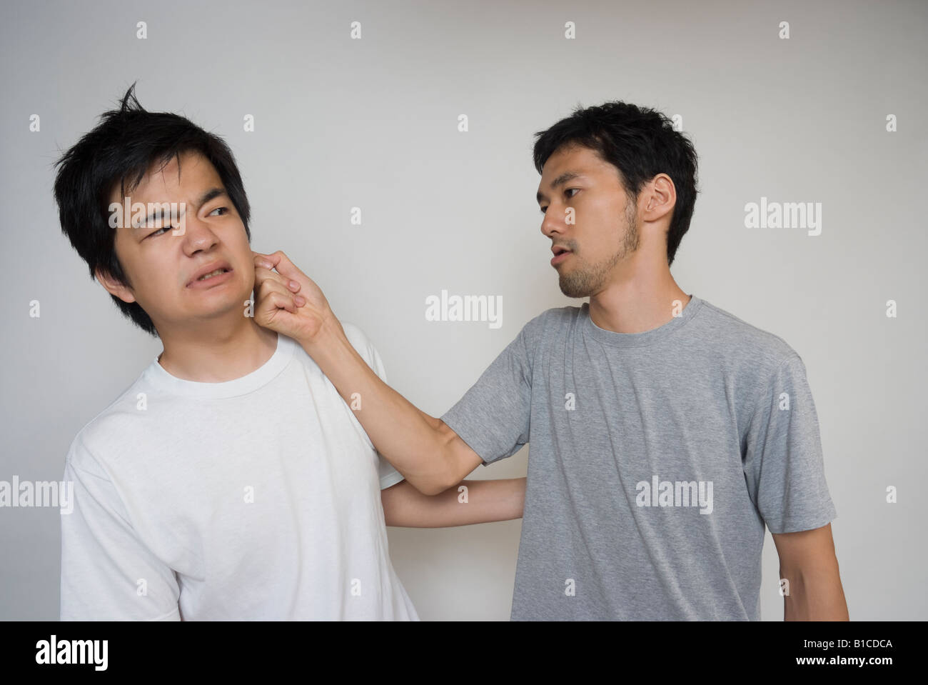 Two young men fighting Stock Photo - Alamy