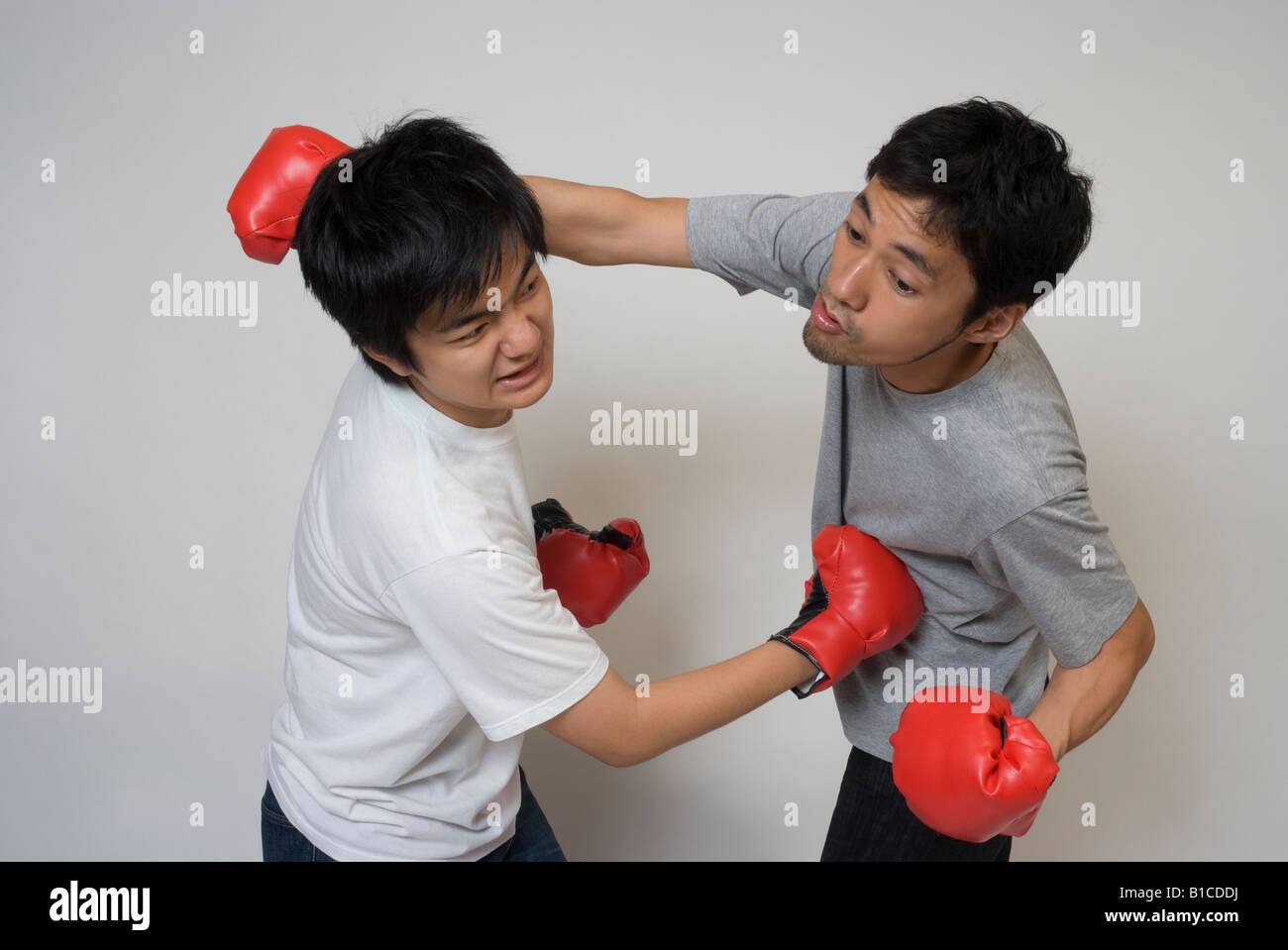 Two young men fighting Stock Photo - Alamy