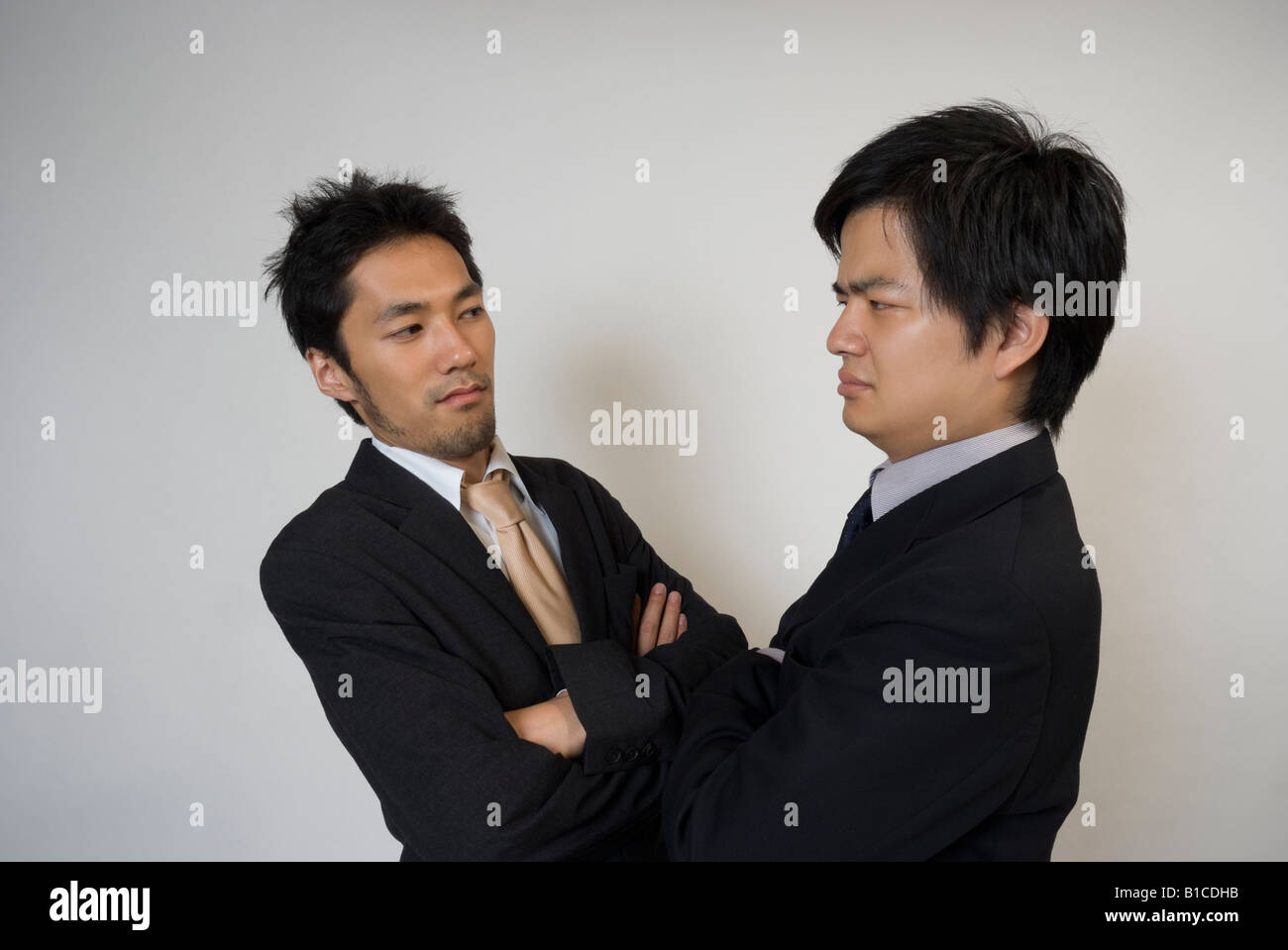 Two businessmen glaring each other Stock Photo - Alamy