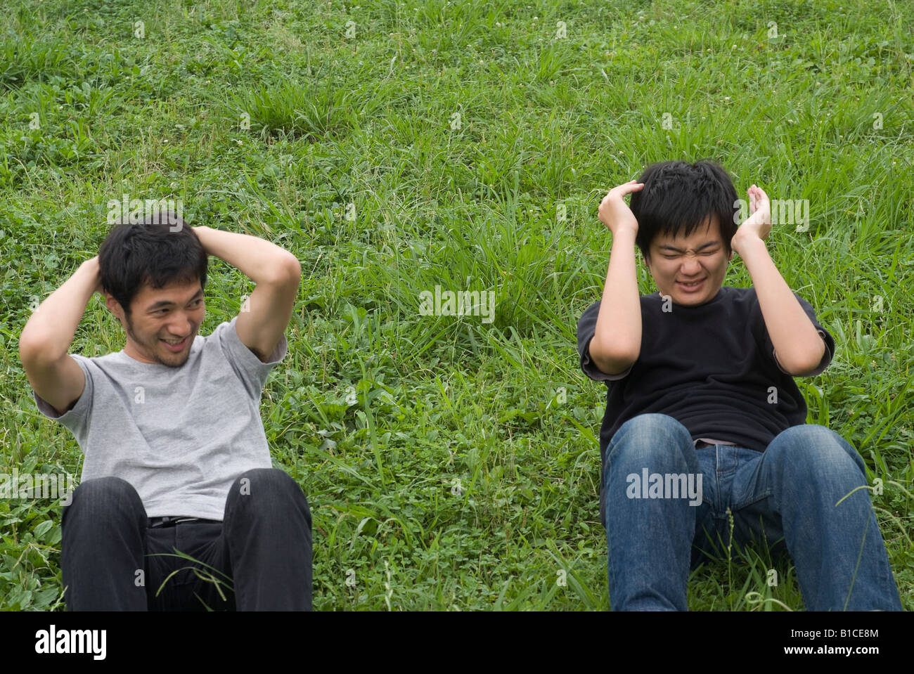 Two young men doing sit-ups Stock Photo - Alamy