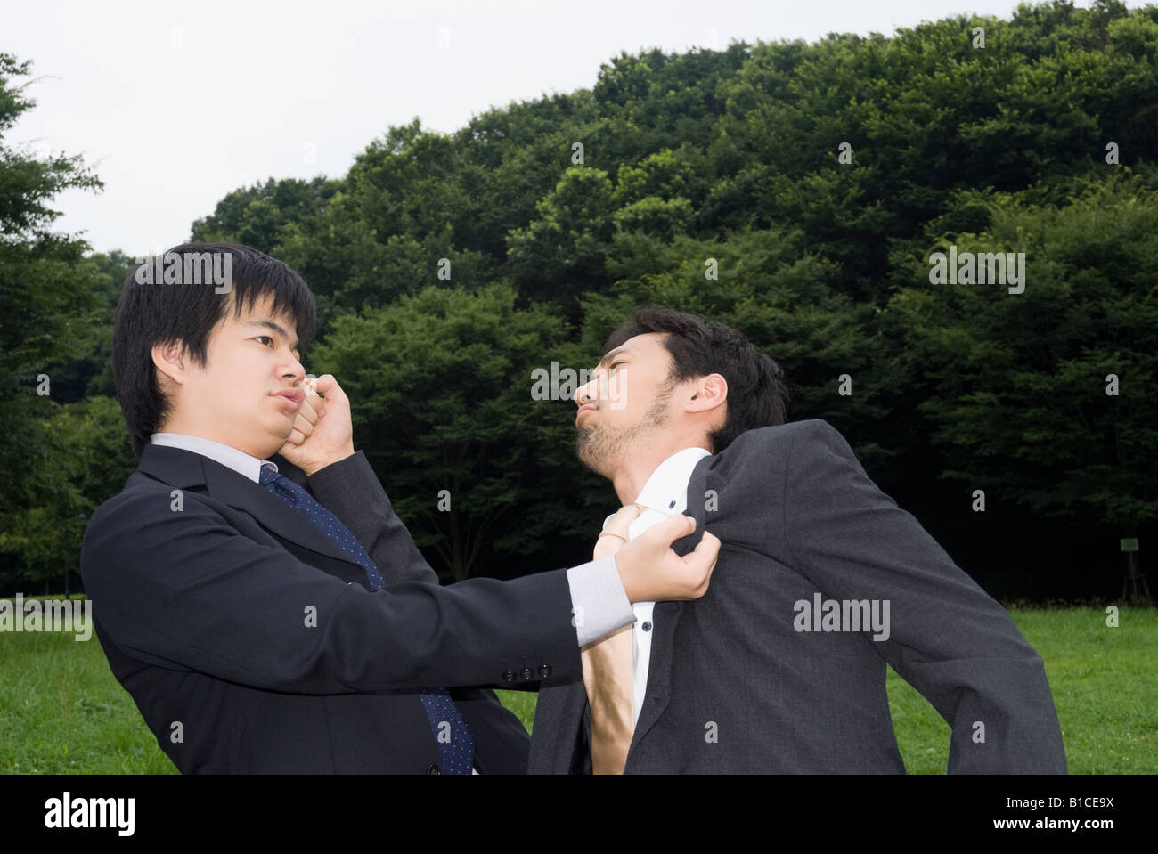 Two businessmen fighting Stock Photo - Alamy