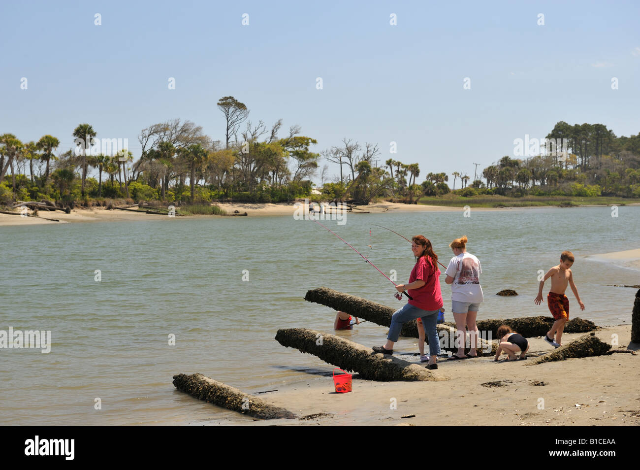 Local family fishing in the lagoon on Hunting Island, South Carolina ...