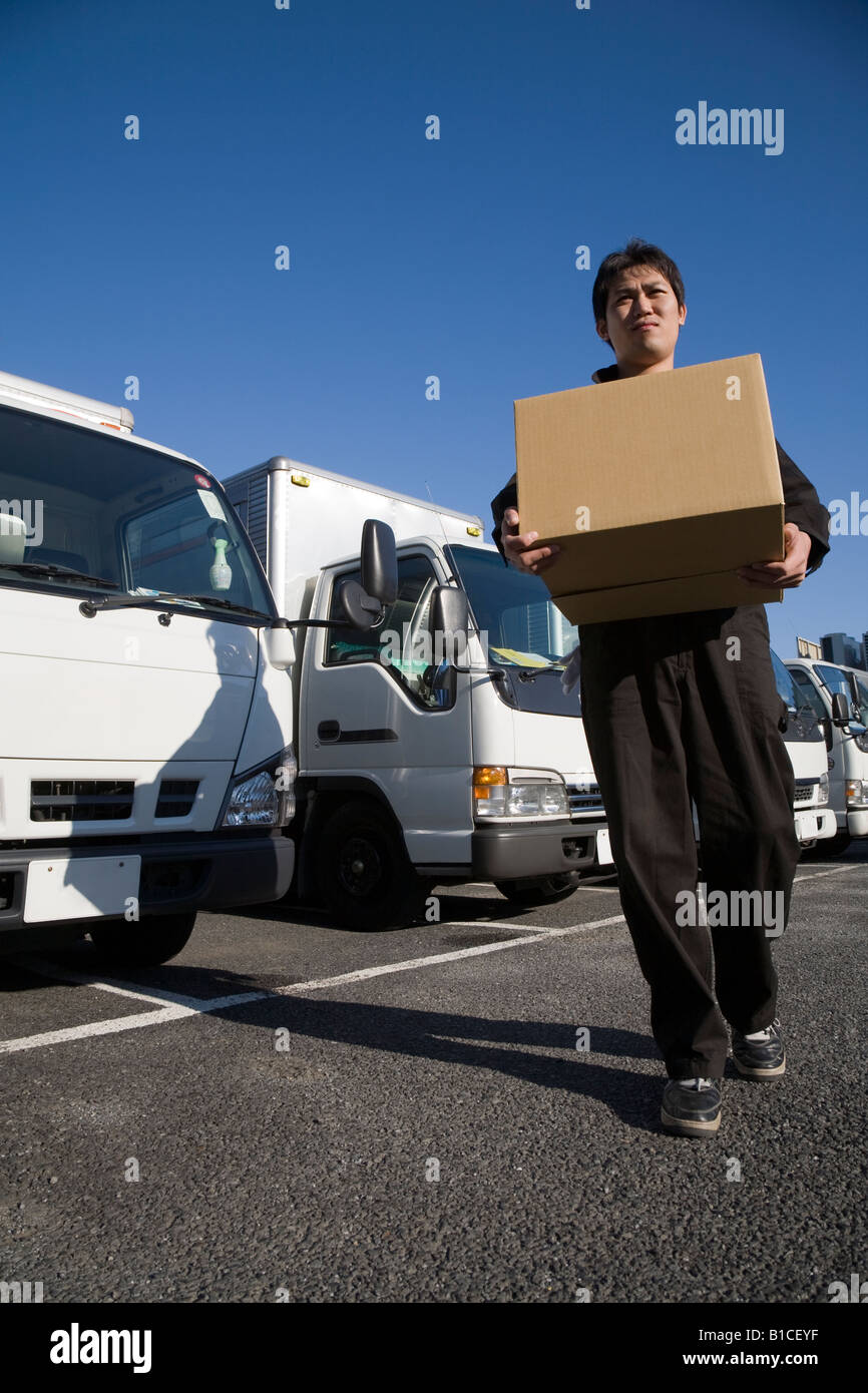 Young japanese delivery man box hi-res stock photography and images - Alamy