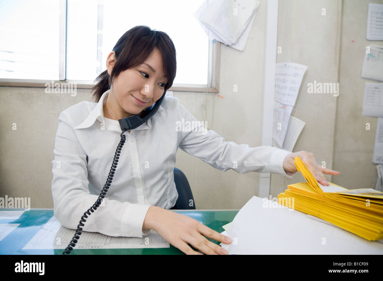 Young woman talking over telephone Stock Photo - Alamy