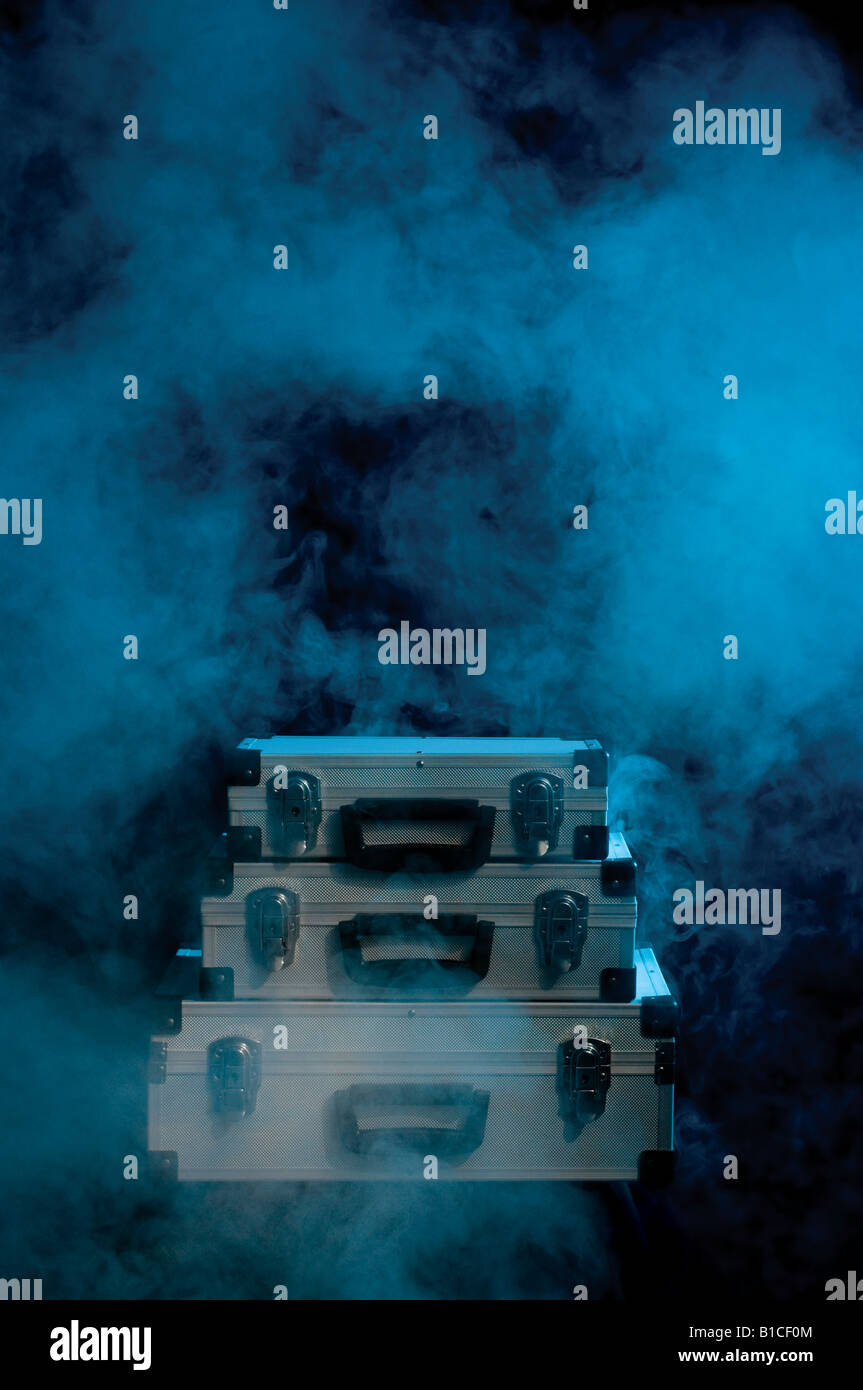 Stack of metal suitcases in smoke Stock Photo - Alamy