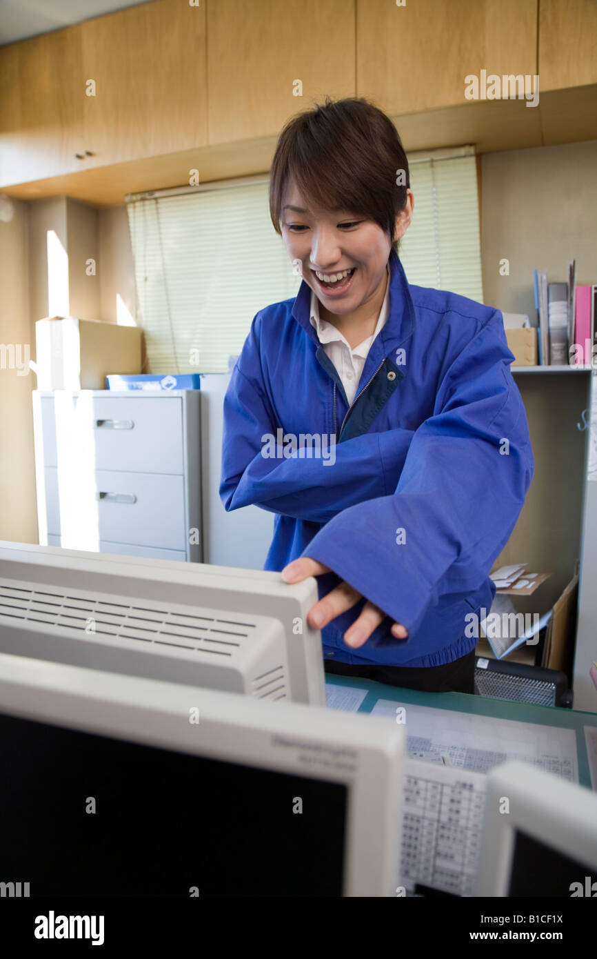 Young woman looking at computer monitor Stock Photo - Alamy