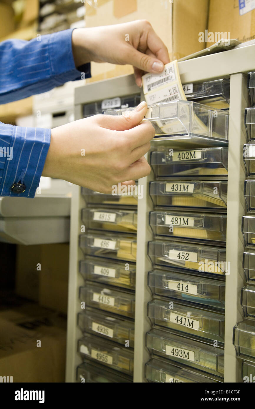 Young woman looking for document Stock Photo - Alamy
