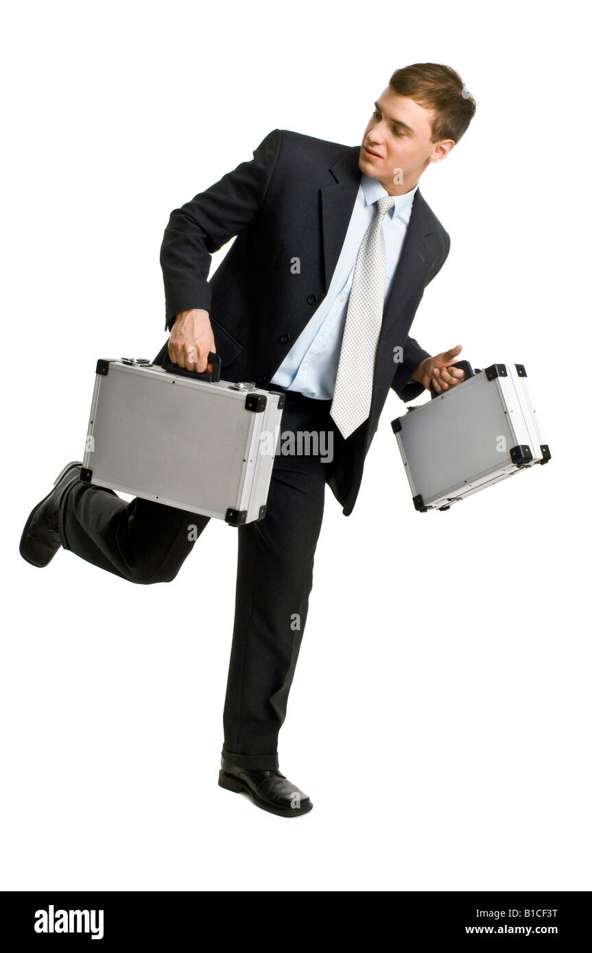Businessman running with suitcases Stock Photo - Alamy