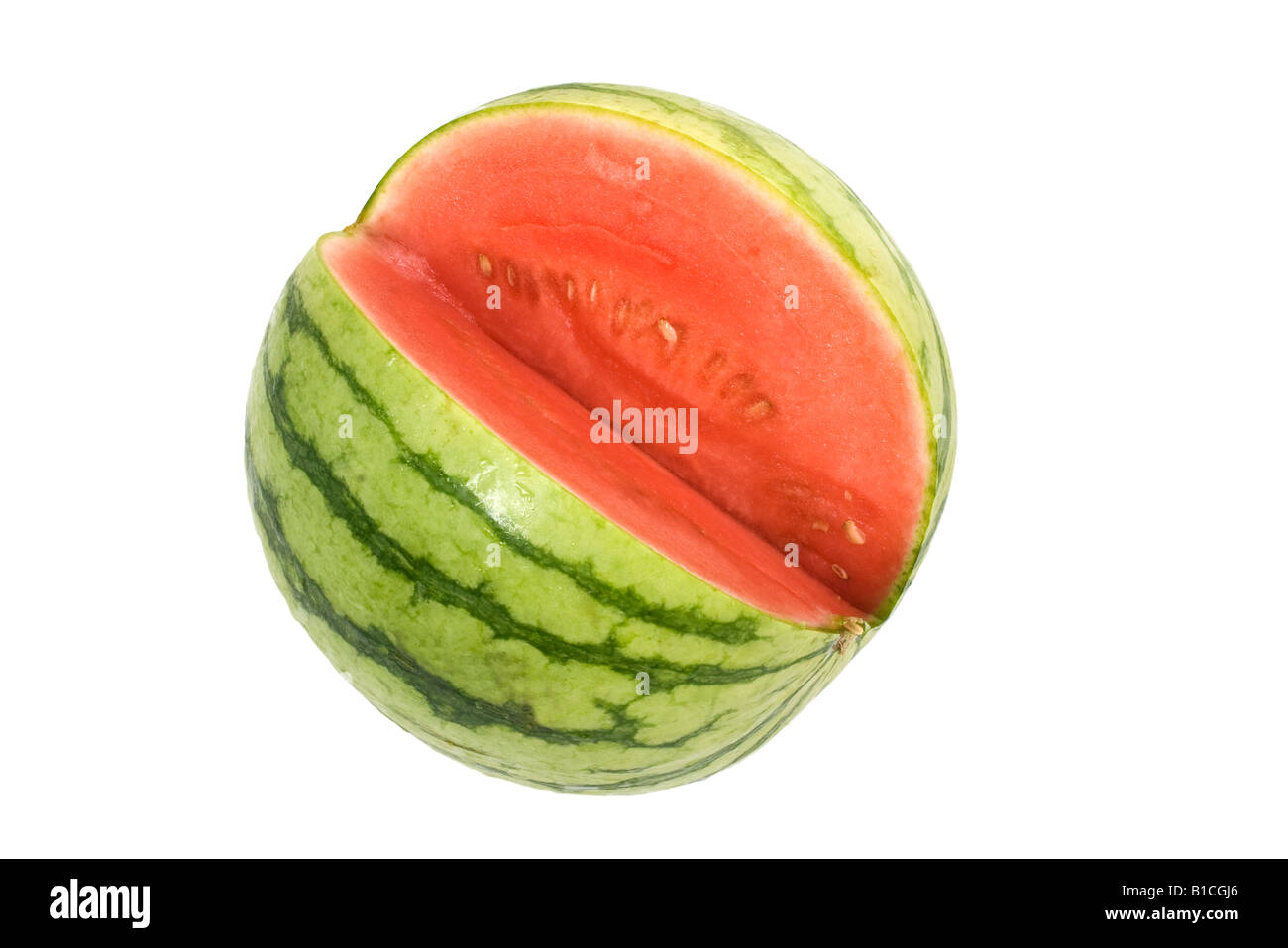 A fresh personal watermelon with a wedge removed showing the beautiful ...