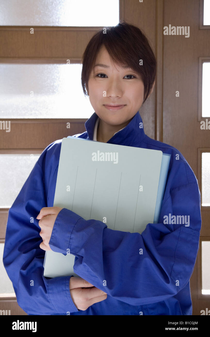 Young woman holding files Stock Photo - Alamy