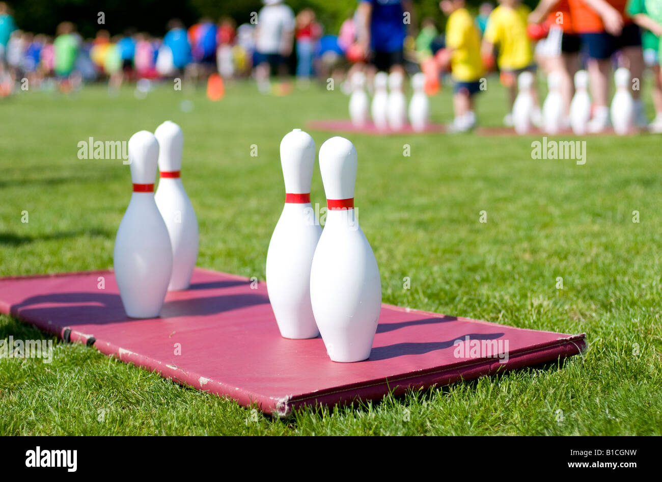Bowling pins on a mat during children's game outside Stock Photo - Alamy