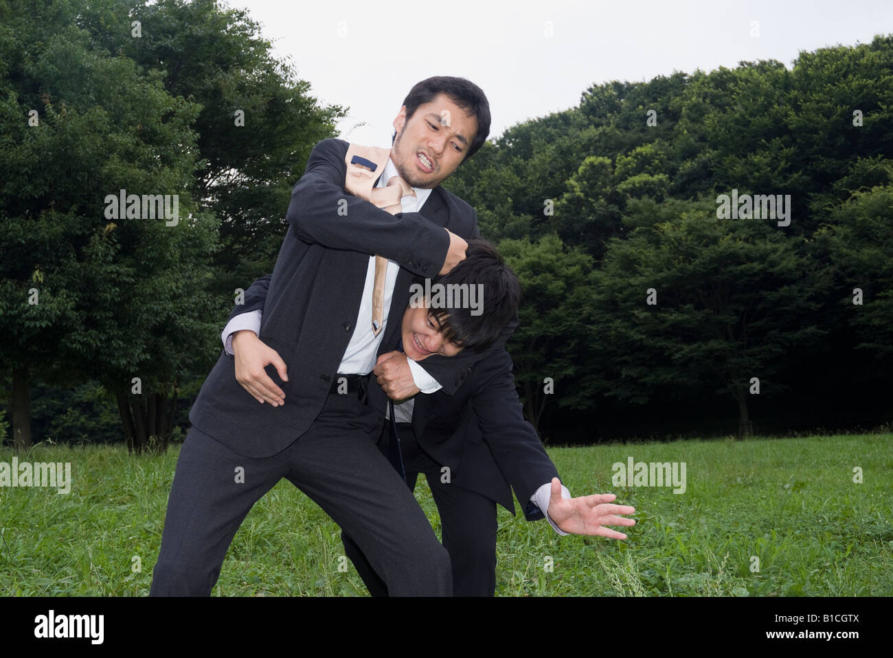 Two businessmen fighting Stock Photo - Alamy