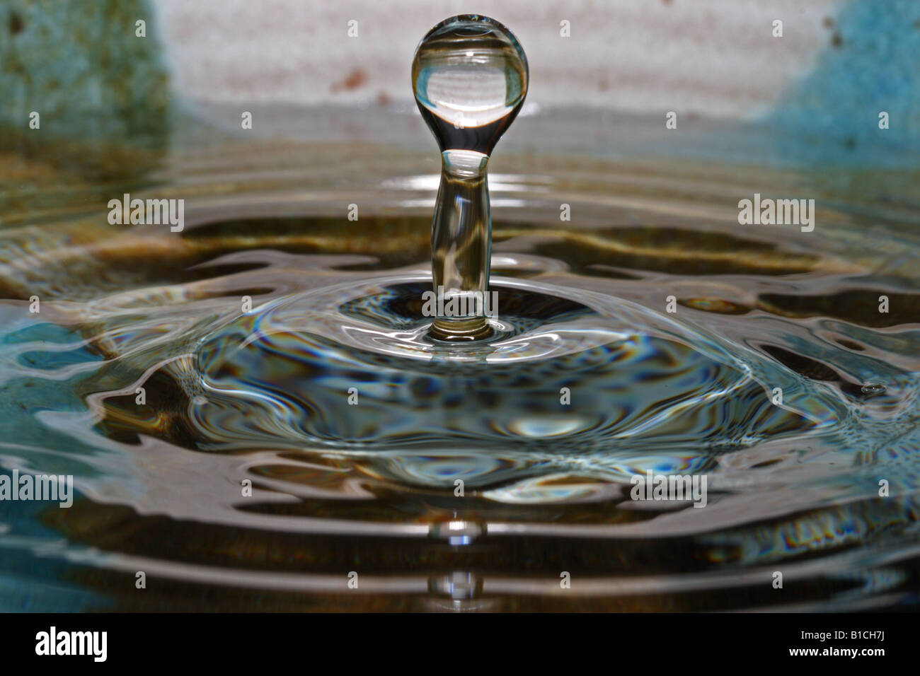 Water drop hitting surface of clear water Stock Photo - Alamy
