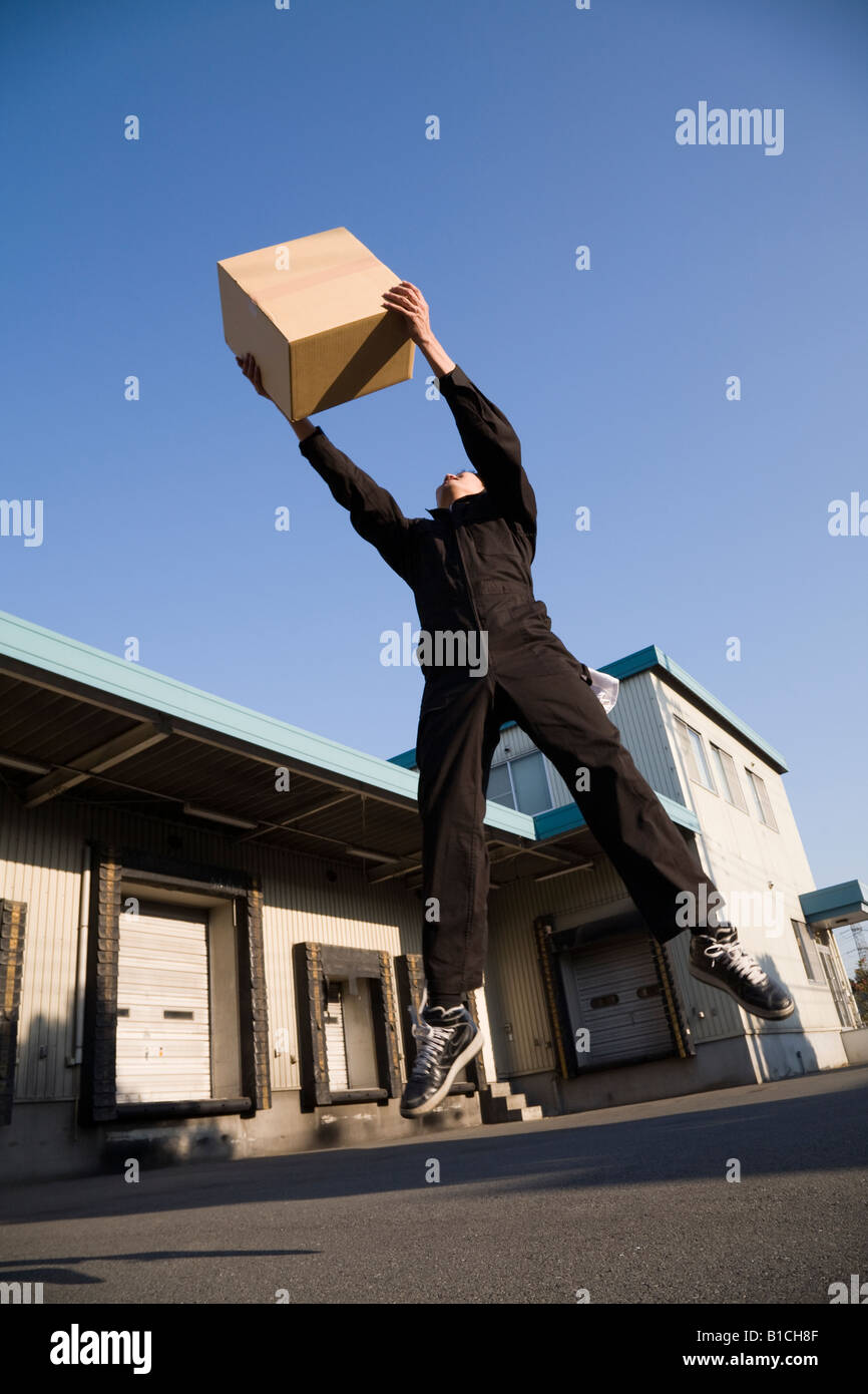 Young worker jumping Stock Photo - Alamy