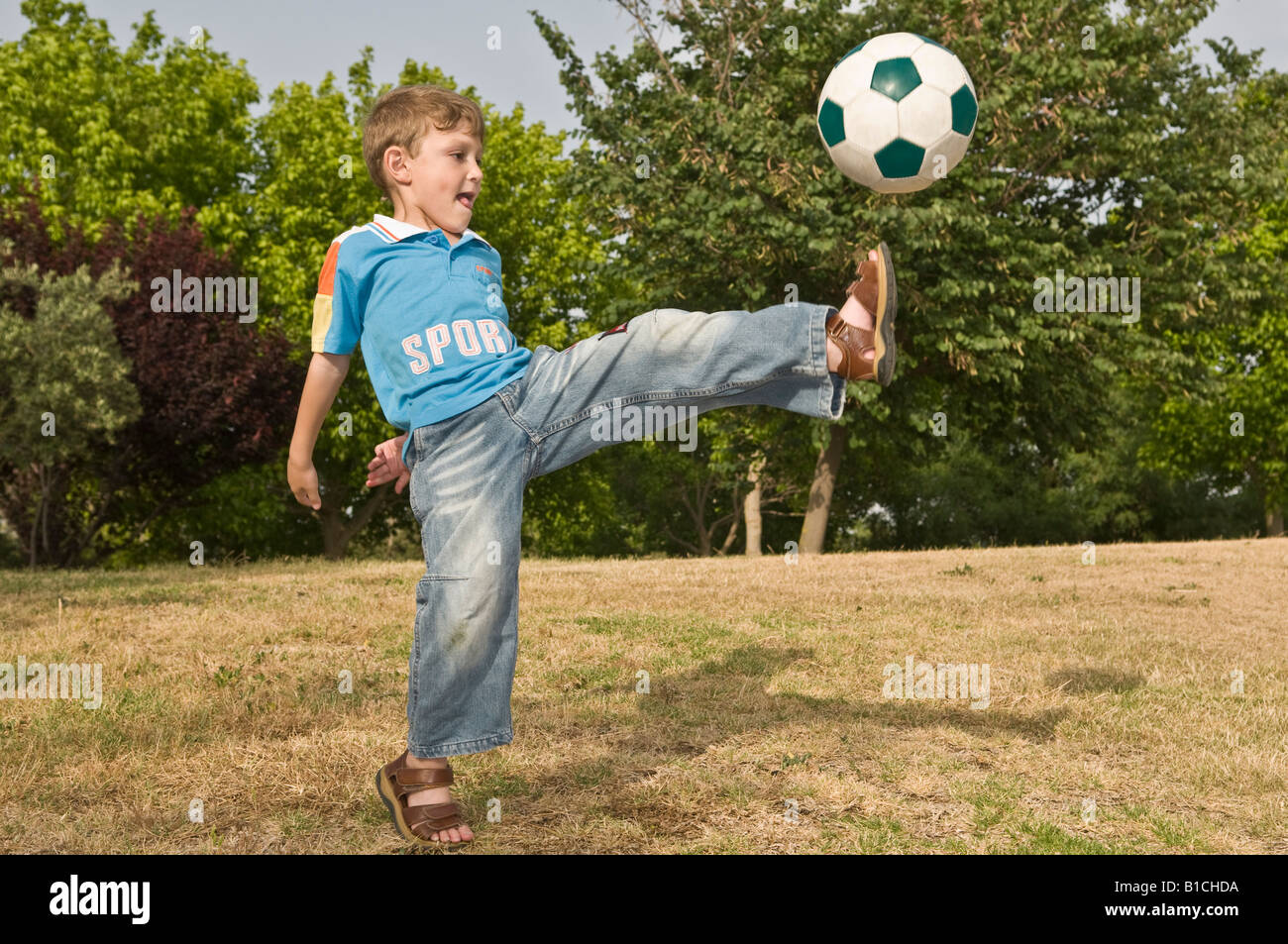 Game in football the boy strikes very much on a ball on a childrens ...