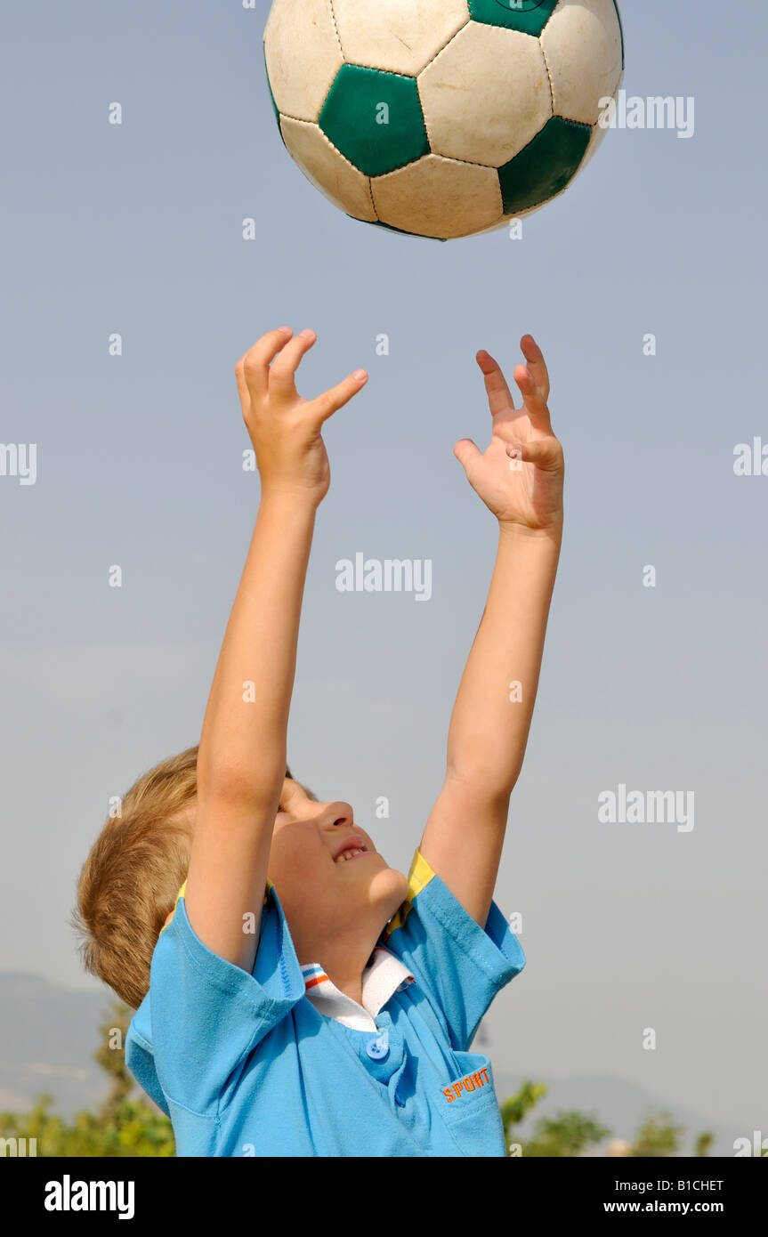 The boy catches the difficult ball Stock Photo - Alamy