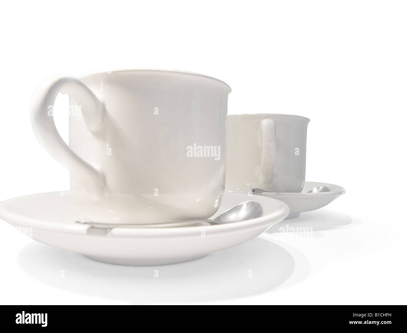 Two white coffee cups isolated on a white background Stock Photo - Alamy