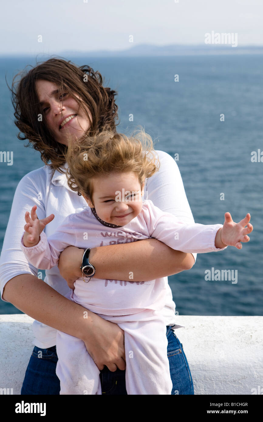Young woman with her daughter in a windy terrace in Casapueblo Punta ...