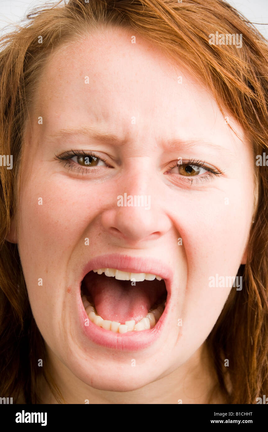 red haired angry furious woman girl shouting yelling and screaming ...