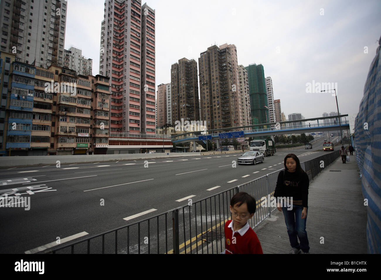 Mother and child walking along the Road Ferry Street in Kowloon ...