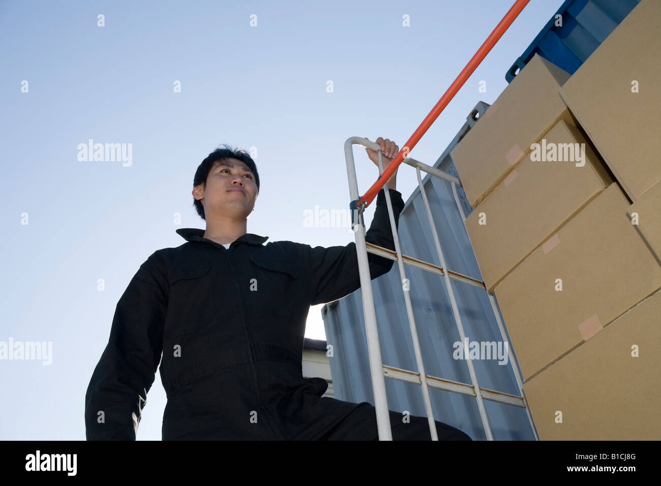 Young worker carrying boxes Stock Photo - Alamy
