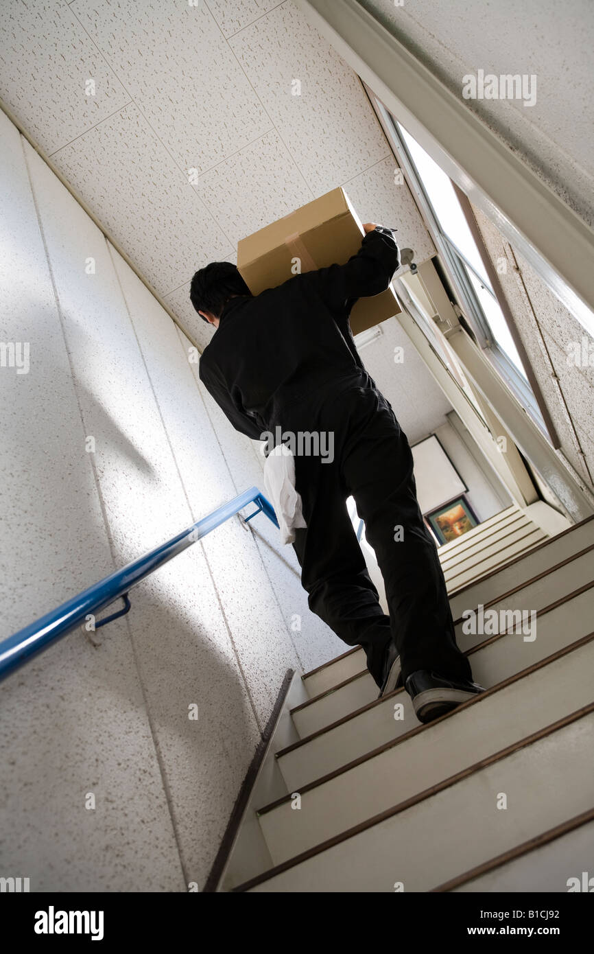 Rear view young man carrying hi-res stock photography and images - Alamy