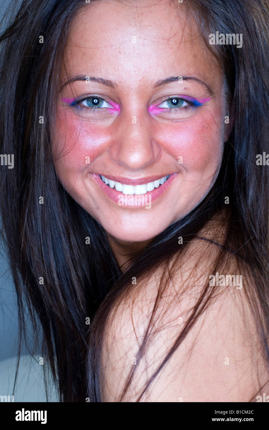 young rouged woman with messy hair, smiling Stock Photo - Alamy