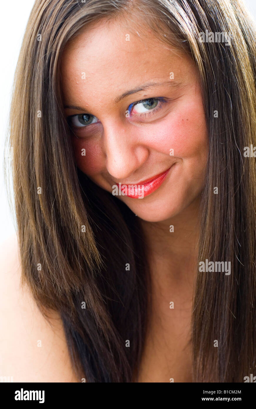young rouged woman with long brown hair and red lips, smiling Stock ...