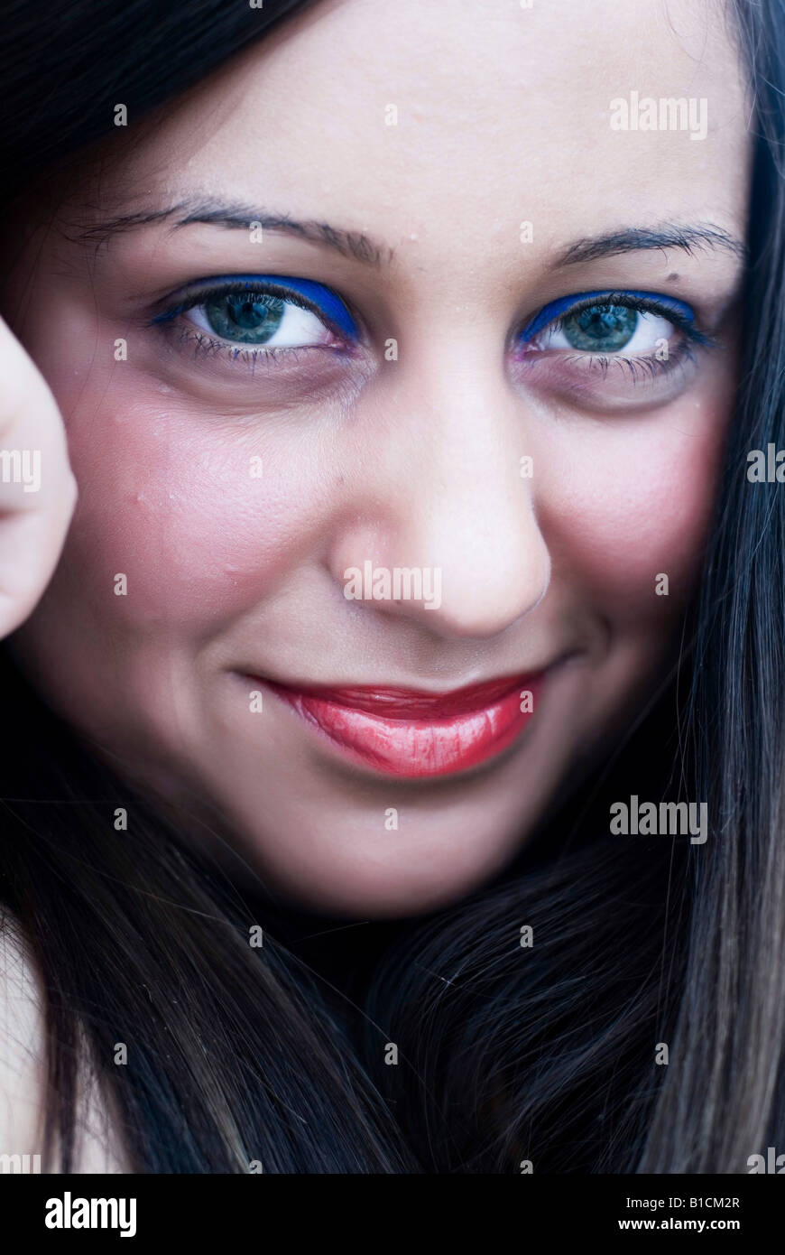 young rouged woman with long brown hair and red lips, smiling Stock ...