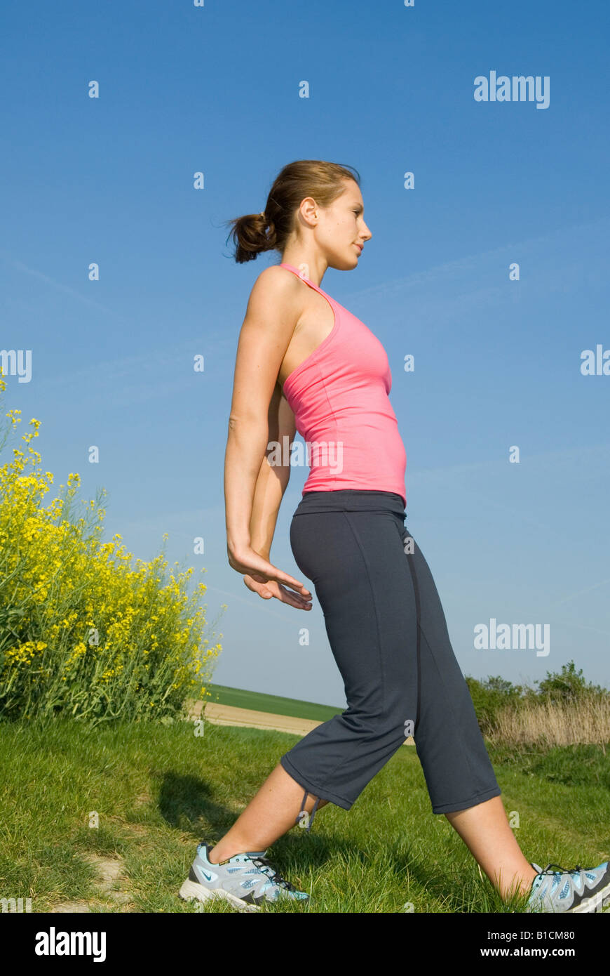 young woman stretching her inner calves musculature Stock Photo - Alamy