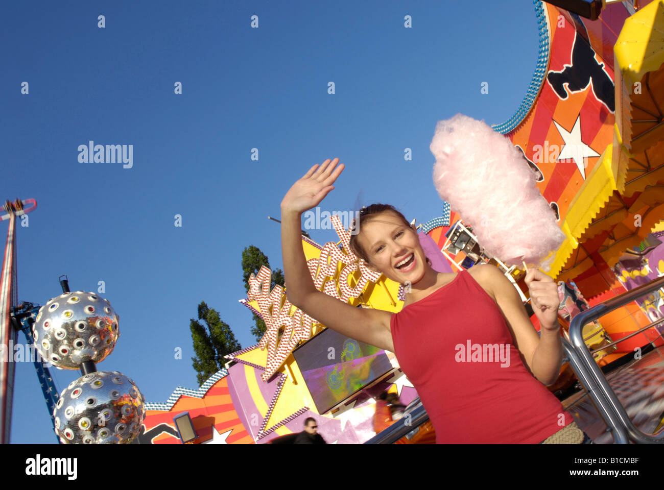 happy young woman with candy floss at the amusement park Wiener Prater ...