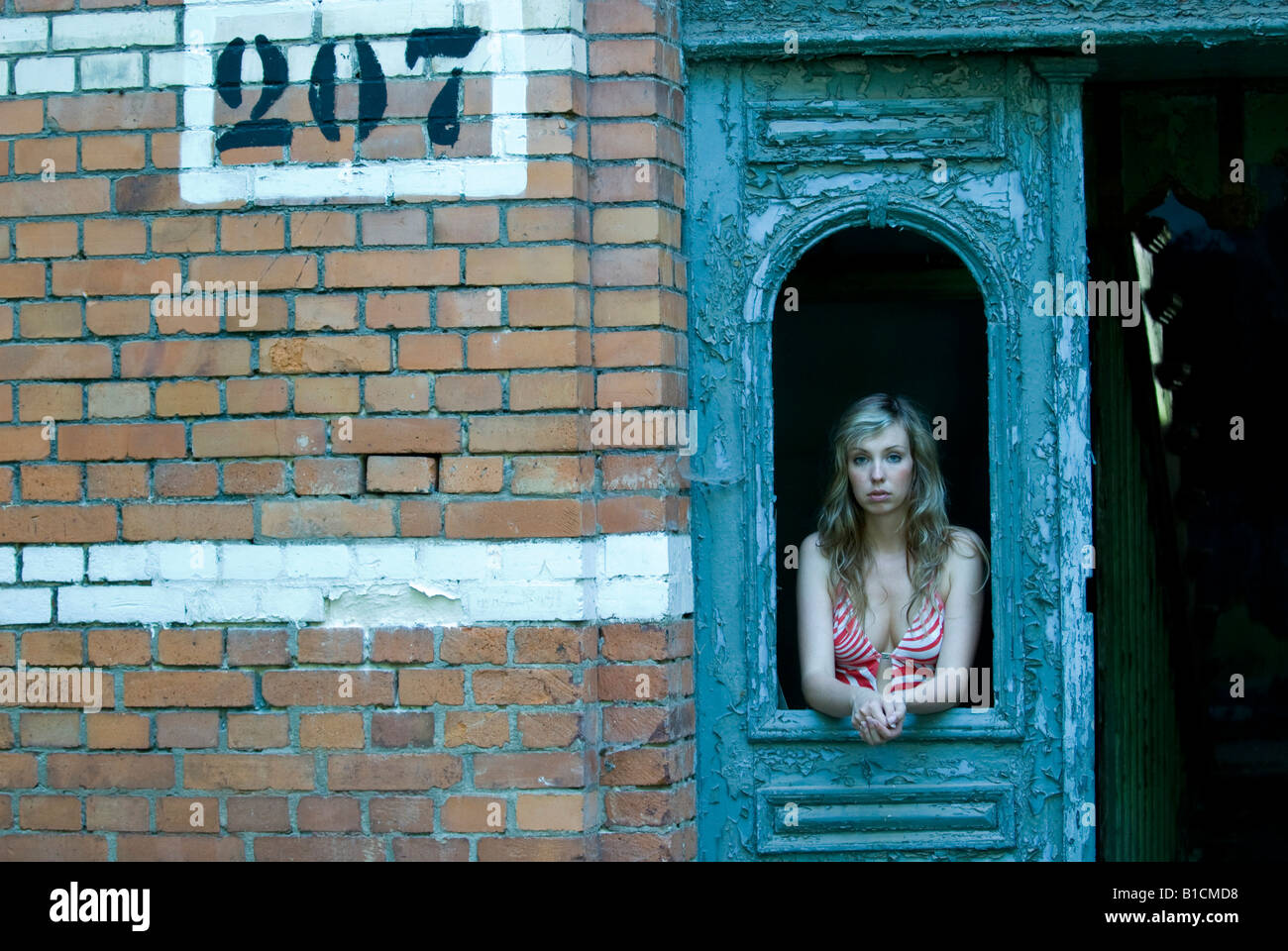 young woman posing in an entrance door of a desolate vacant house Stock ...