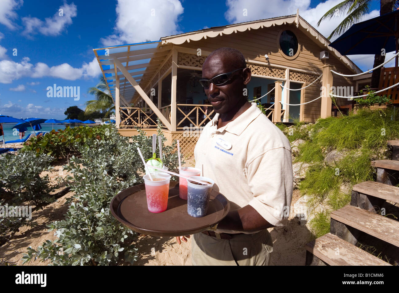 Waiter serving cold drinks at beach Suga Suga Beach bar Mullins Bay ...